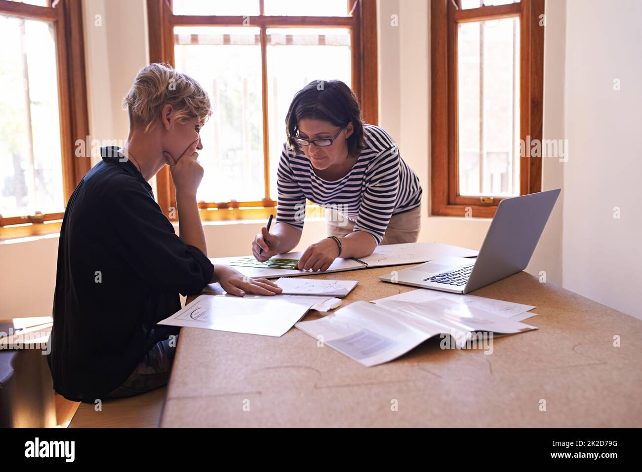 Creativity at work.... A cropped shot of two focused women working ...