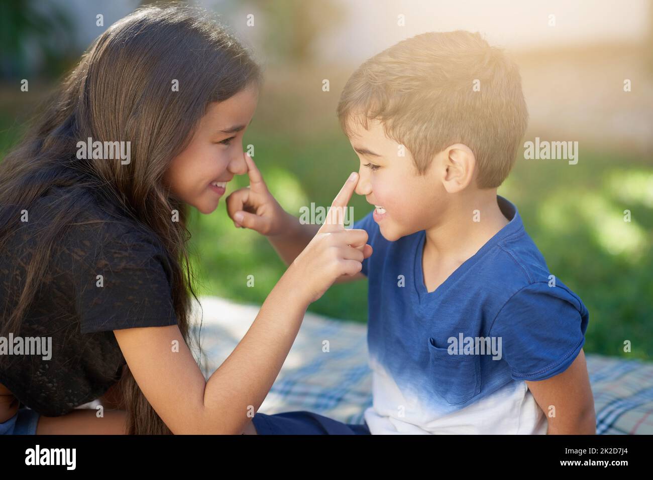 Working on their secret sibling code. Shot of a young brother and sister touching each others ...