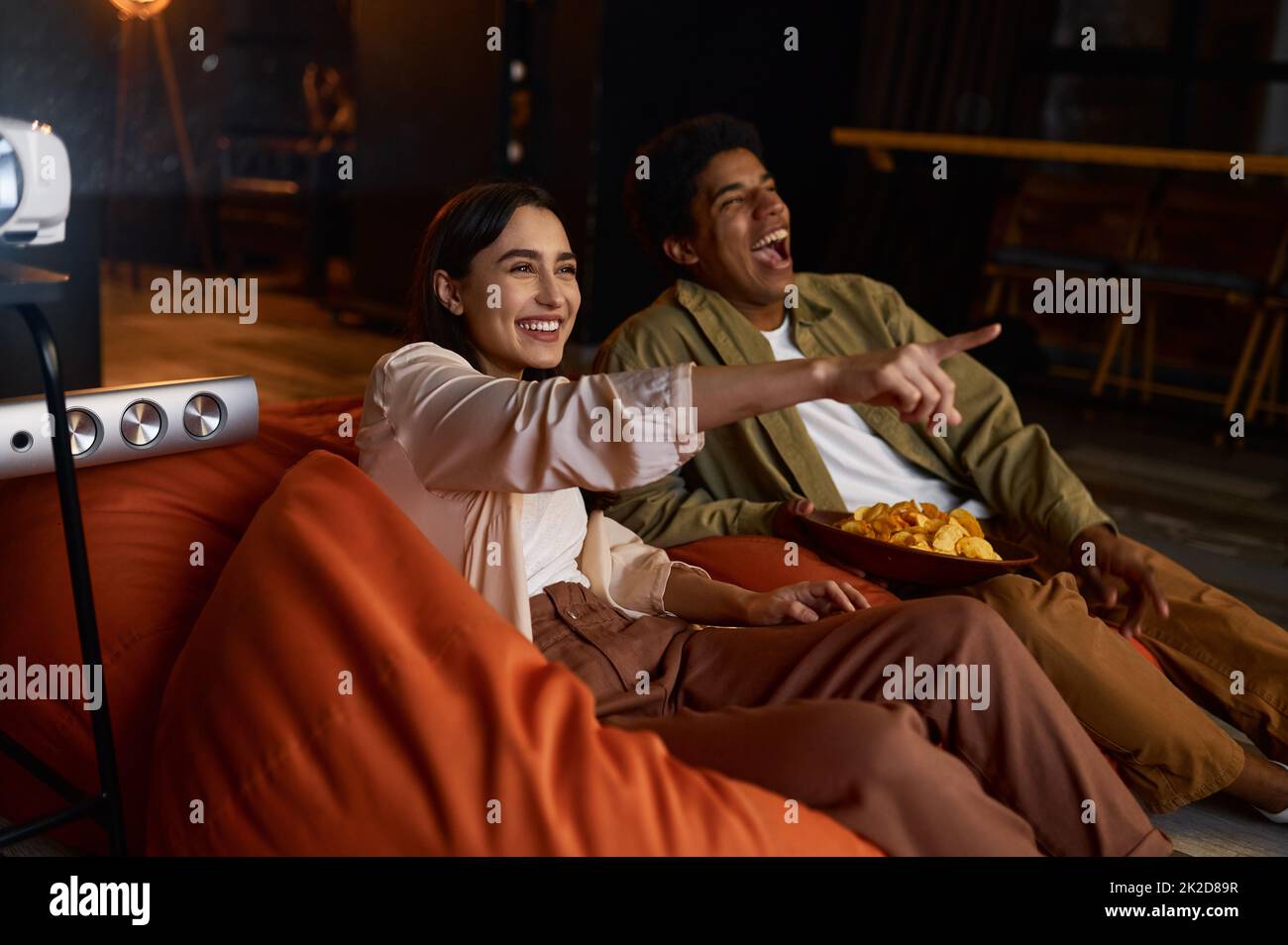 Family couple watching comedian film on projector Stock Photo - Alamy