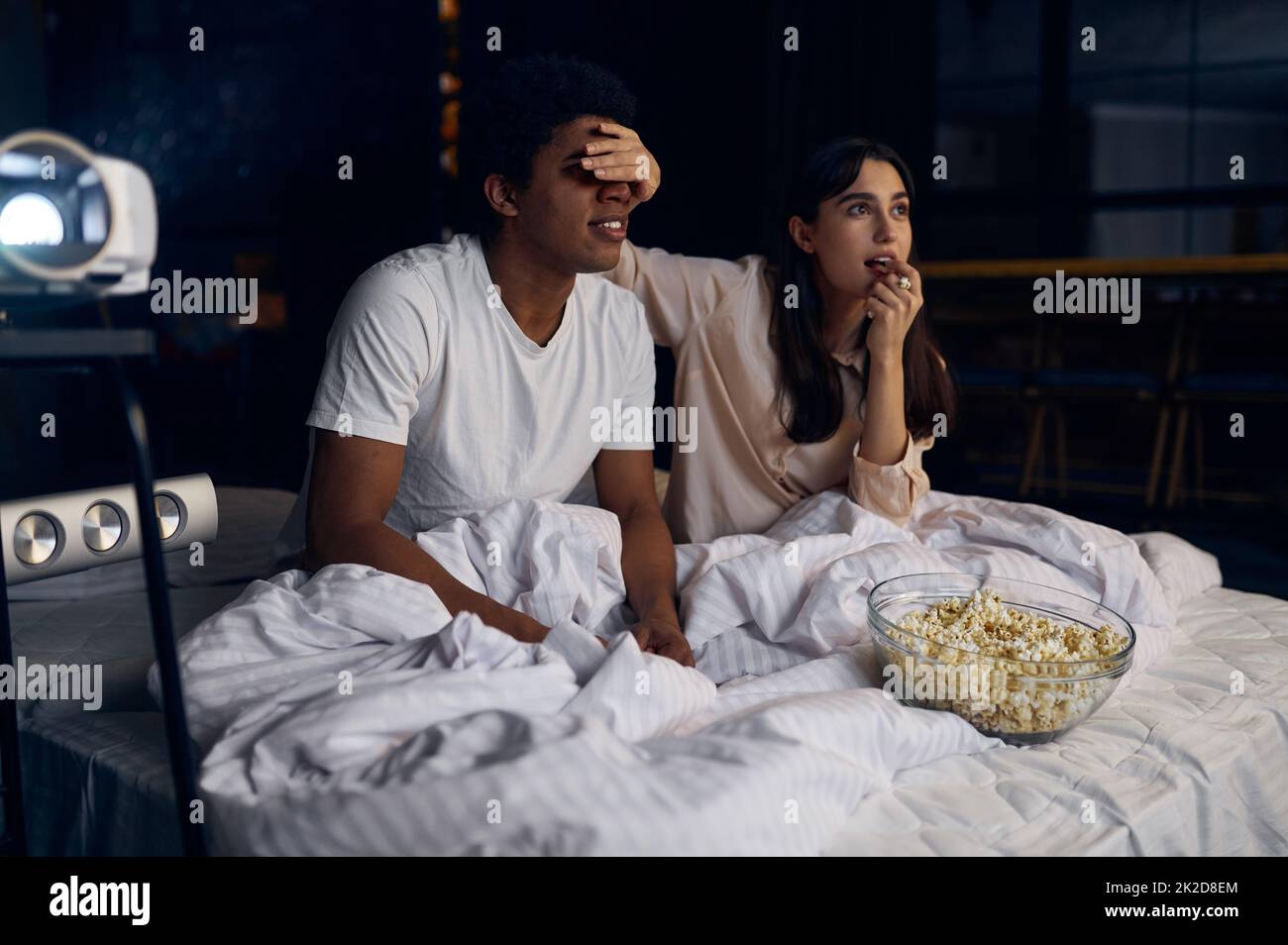 Wife cover husband eyes during film watch Stock Photo - Alamy