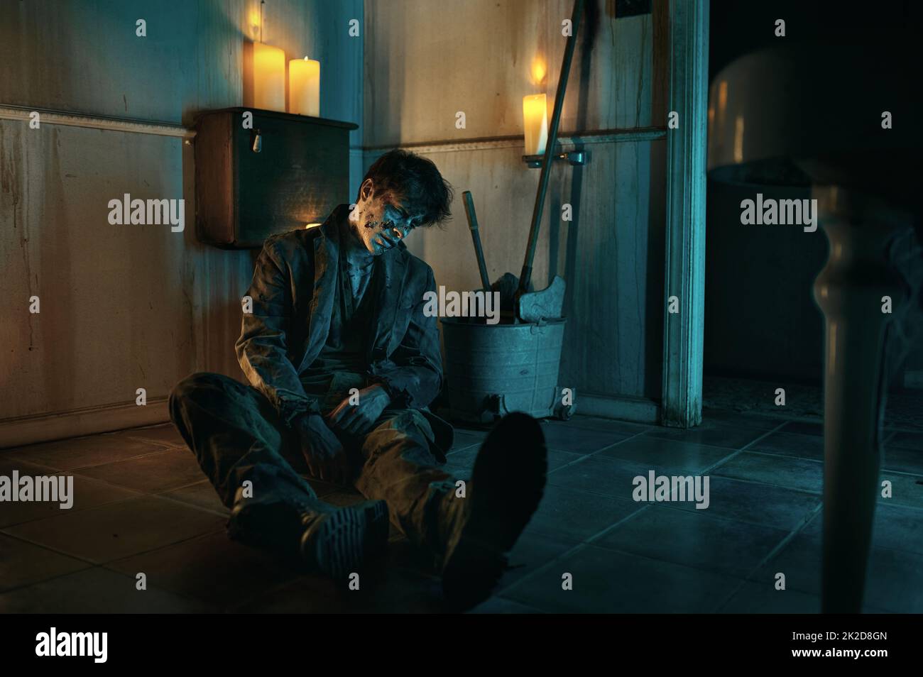 Undead zombie man sitting on lavatory floor Stock Photo - Alamy