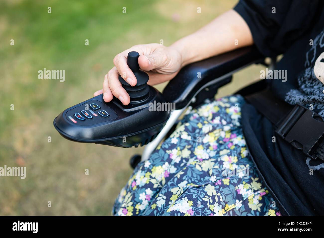 Asian lady woman patient on electric wheelchair with joystick and ...