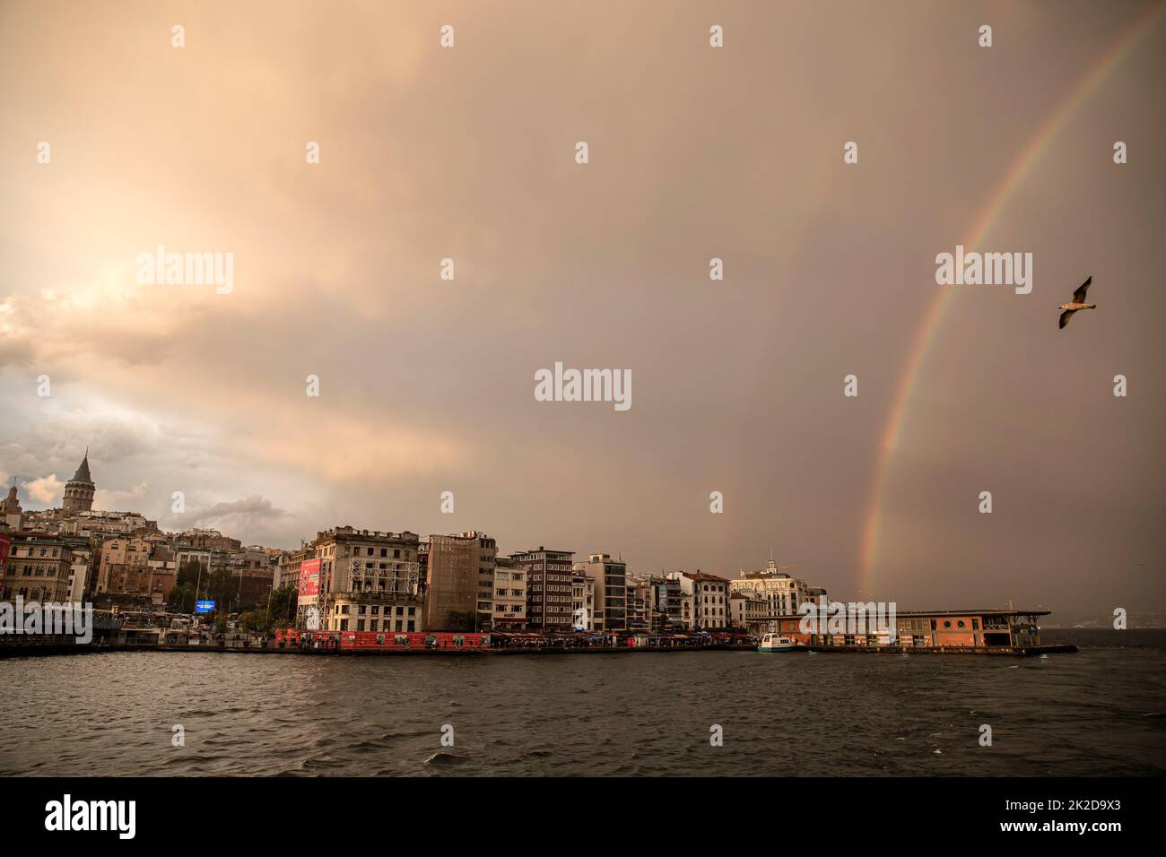 Galata Tower and Karakoy pier seen with the rainbow appearing in the sky. The rainbow seen in ...