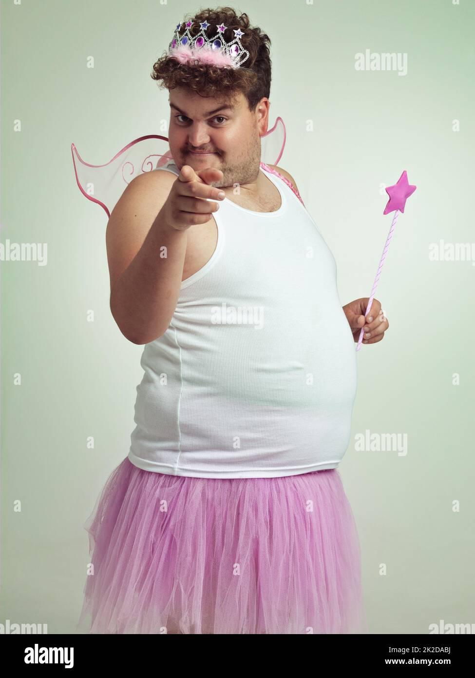 I see you. An overweight man in a pink fairy costume pointing at the ...