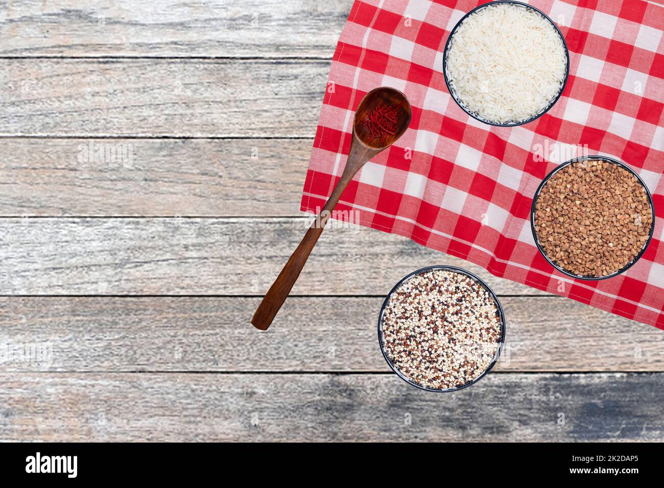 Vegetable food. Closeup of three bowls with rice, buckwheat and quinoa ...