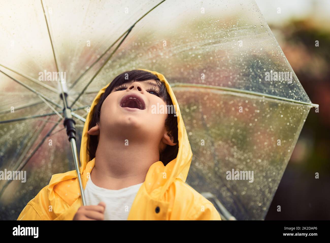 Kids playing rain umbrella hi-res stock photography and images - Alamy