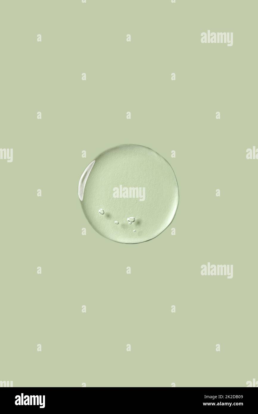 Cosmetic gel drop background. Drop of gel or serum on a pastel green ...