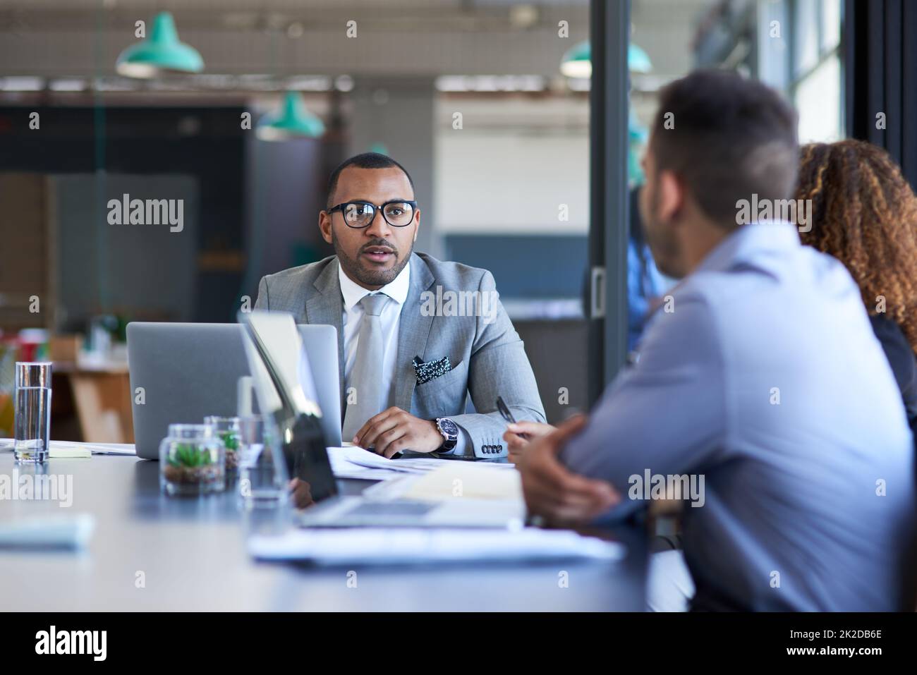 Businessman sitting around boardroom table hi-res stock photography and ...