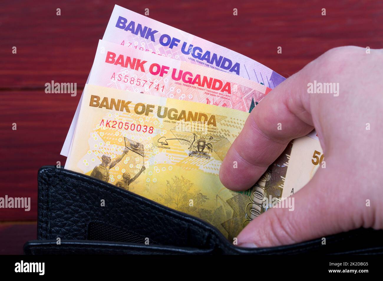 Ugandan money in the black wallet Stock Photo - Alamy