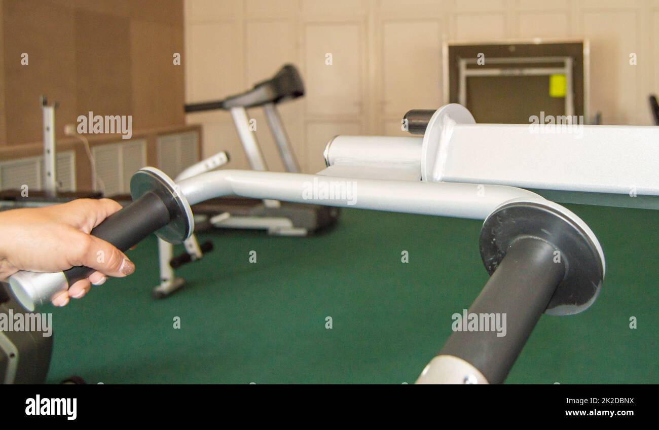 Close-up of a treadmill handle with an adult woman's hand on the ...