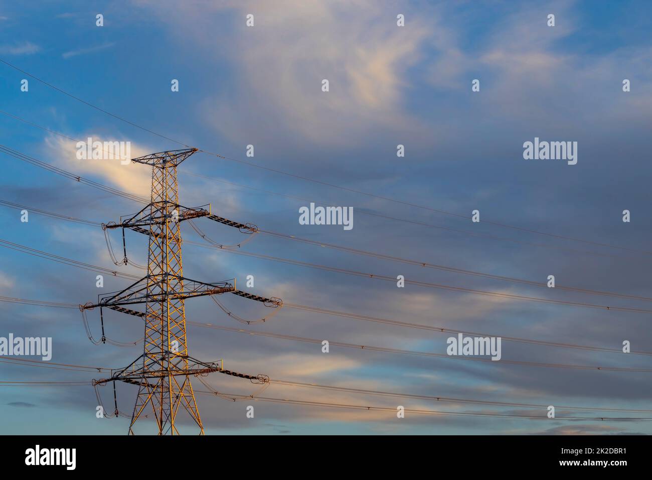 high voltage electric pylon with blue sky Stock Photo - Alamy