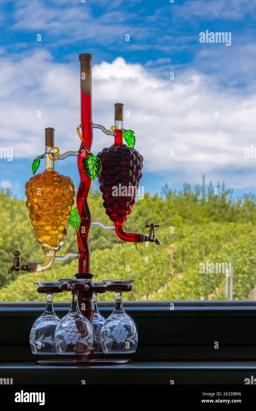 glass carafe with white and red wine in the shape of a grape and ...