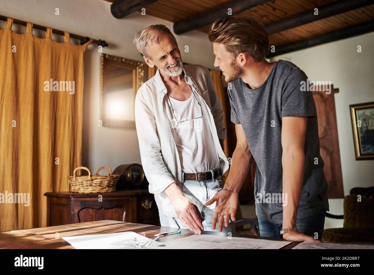 I love your creativity, son. Shot of two men working on a project ...