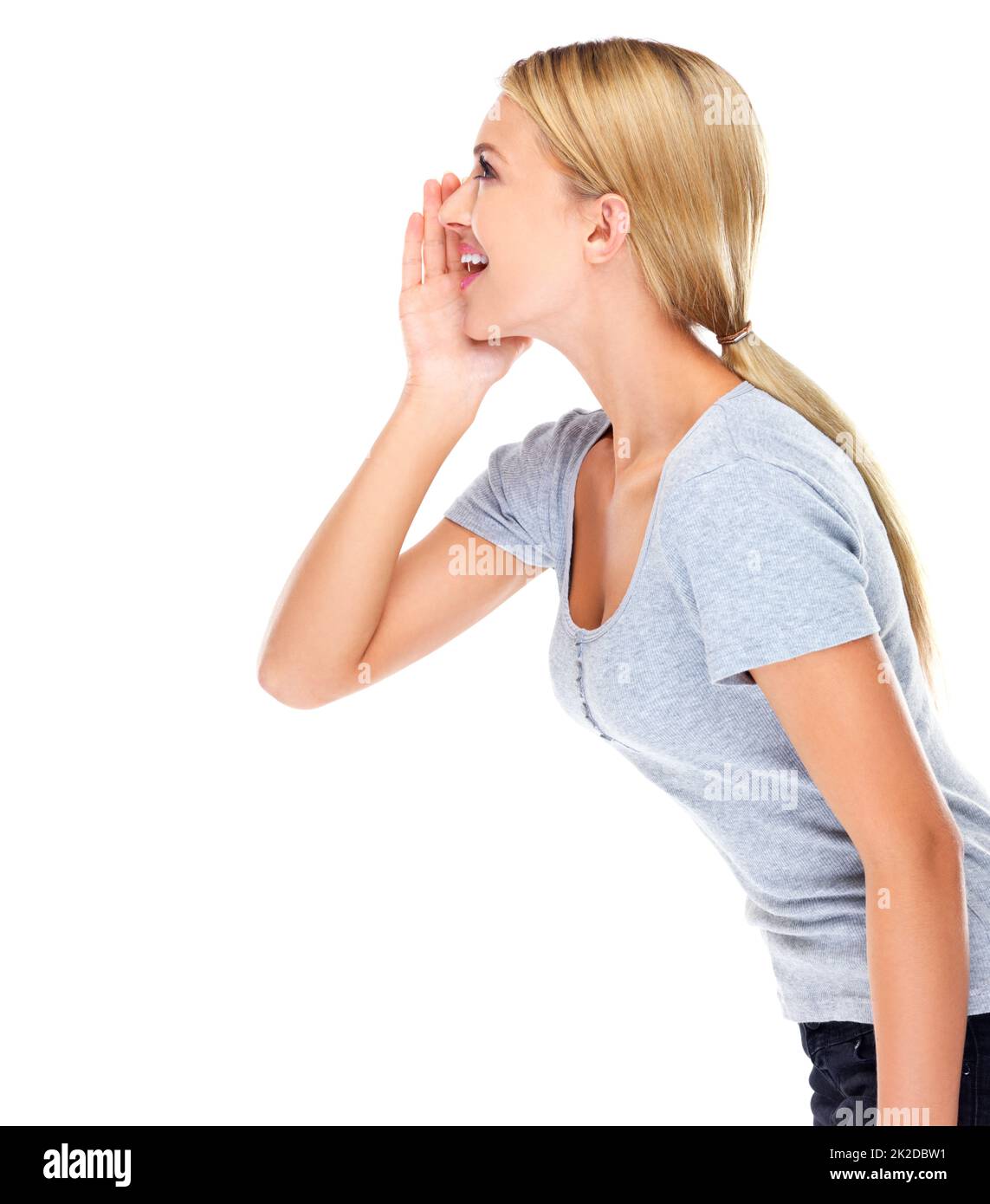 Have you heard. Studio shot of a young woman shouting against a white ...