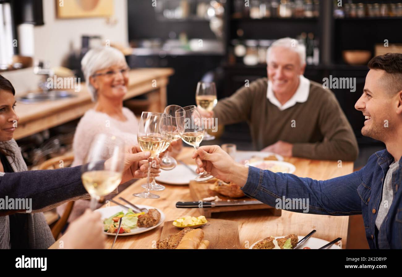 Happy family sitting down dinner hi-res stock photography and images ...