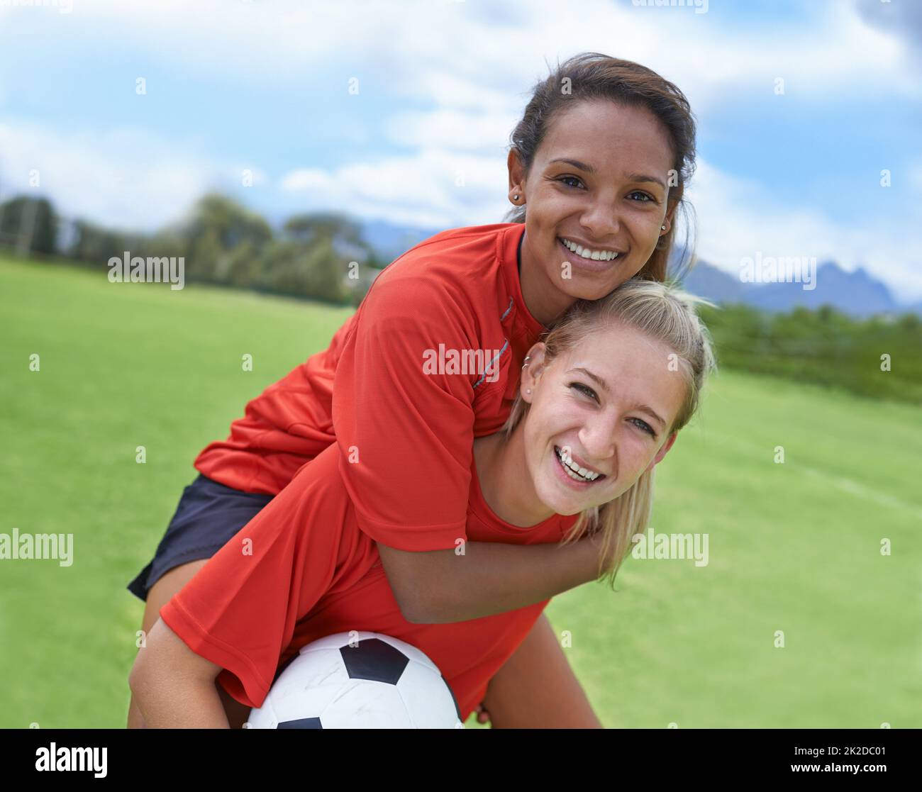Best Friends And Teammates Shot Of A Female Soccer Player Carrying Her Teammate On Her Back
