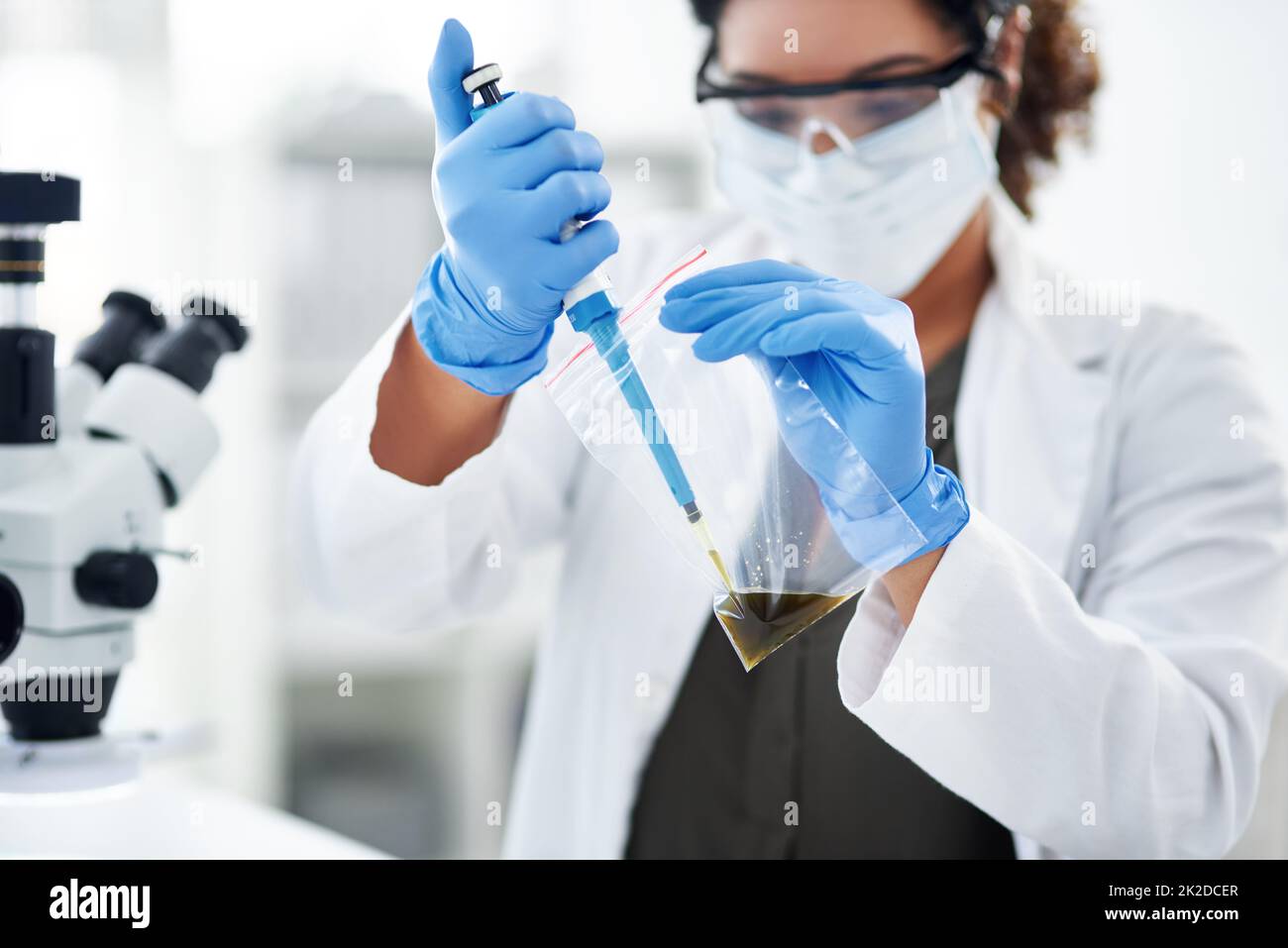 I hope this works. Cropped shot of a scientist conducting an experiment ...