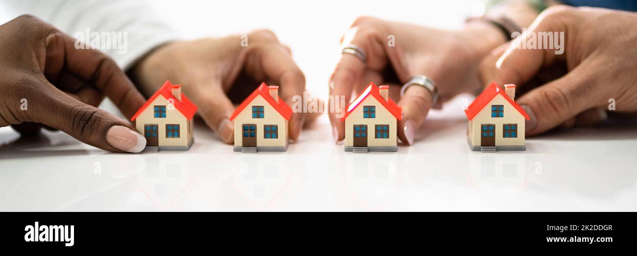 Homeowner Association By People Holding House Model Stock Photo - Alamy