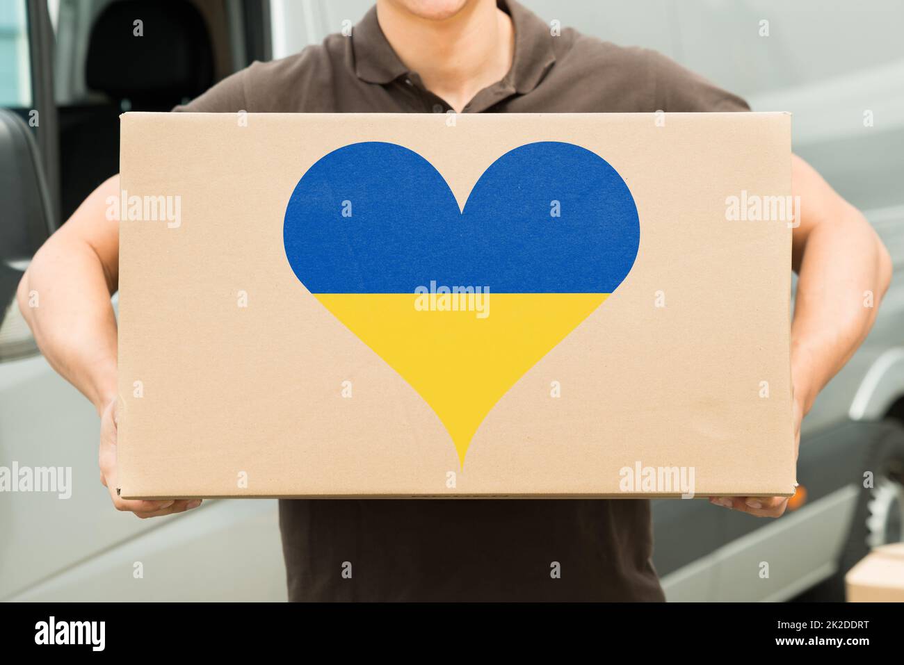 Delivery Man Carrying Box In Hand Stock Photo - Alamy