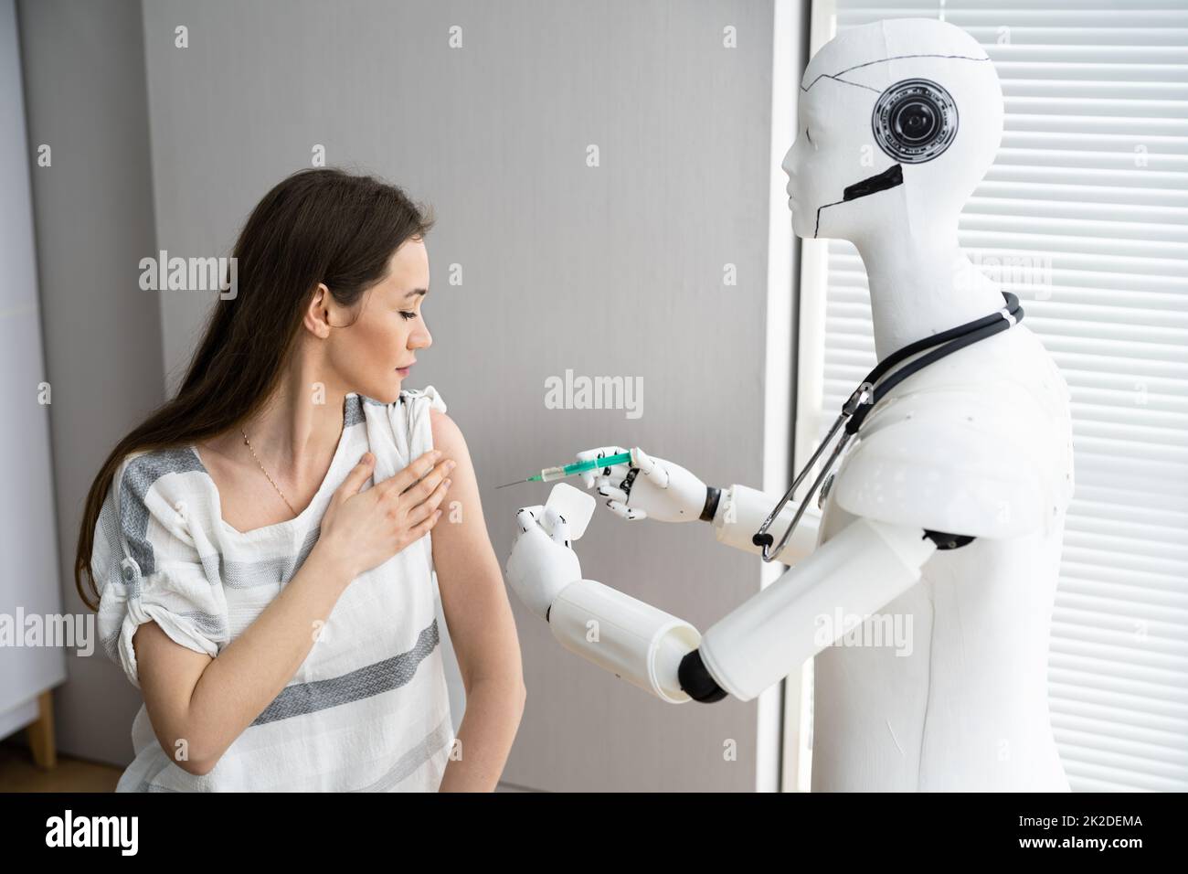 Robot Doctor Injecting Patient Arm Stock Photo - Alamy