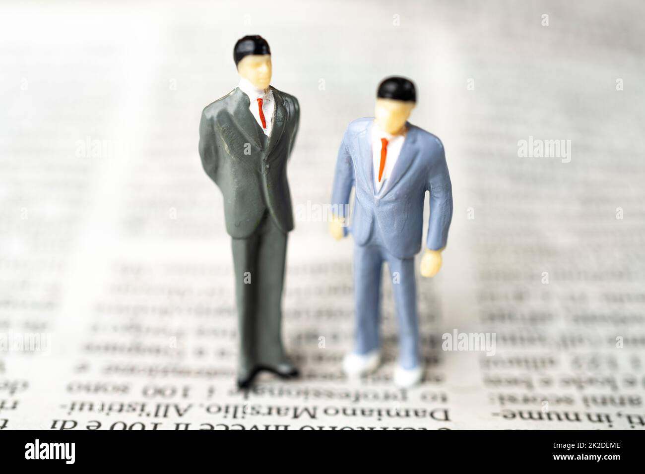 the figurine couple of two men on a page of the newspaper Stock Photo ...