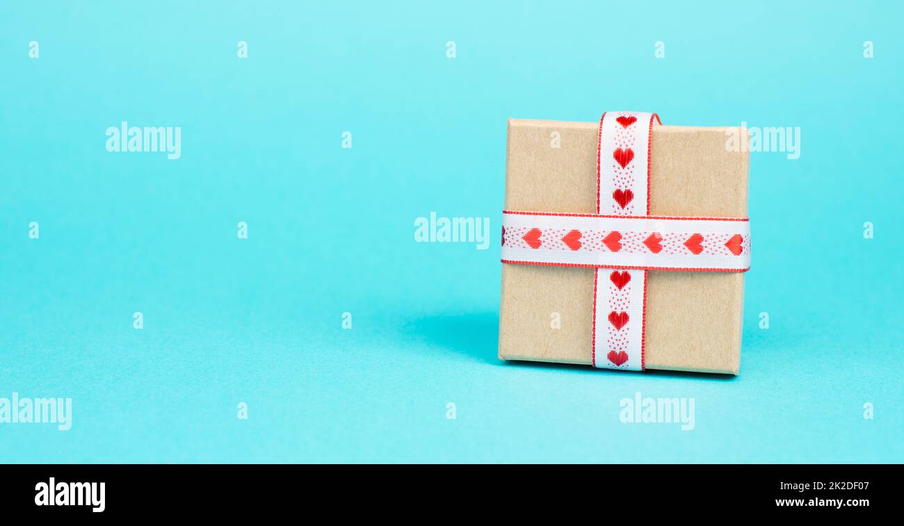 Little gift box with heart ribbon, copy space, background and greeting ...