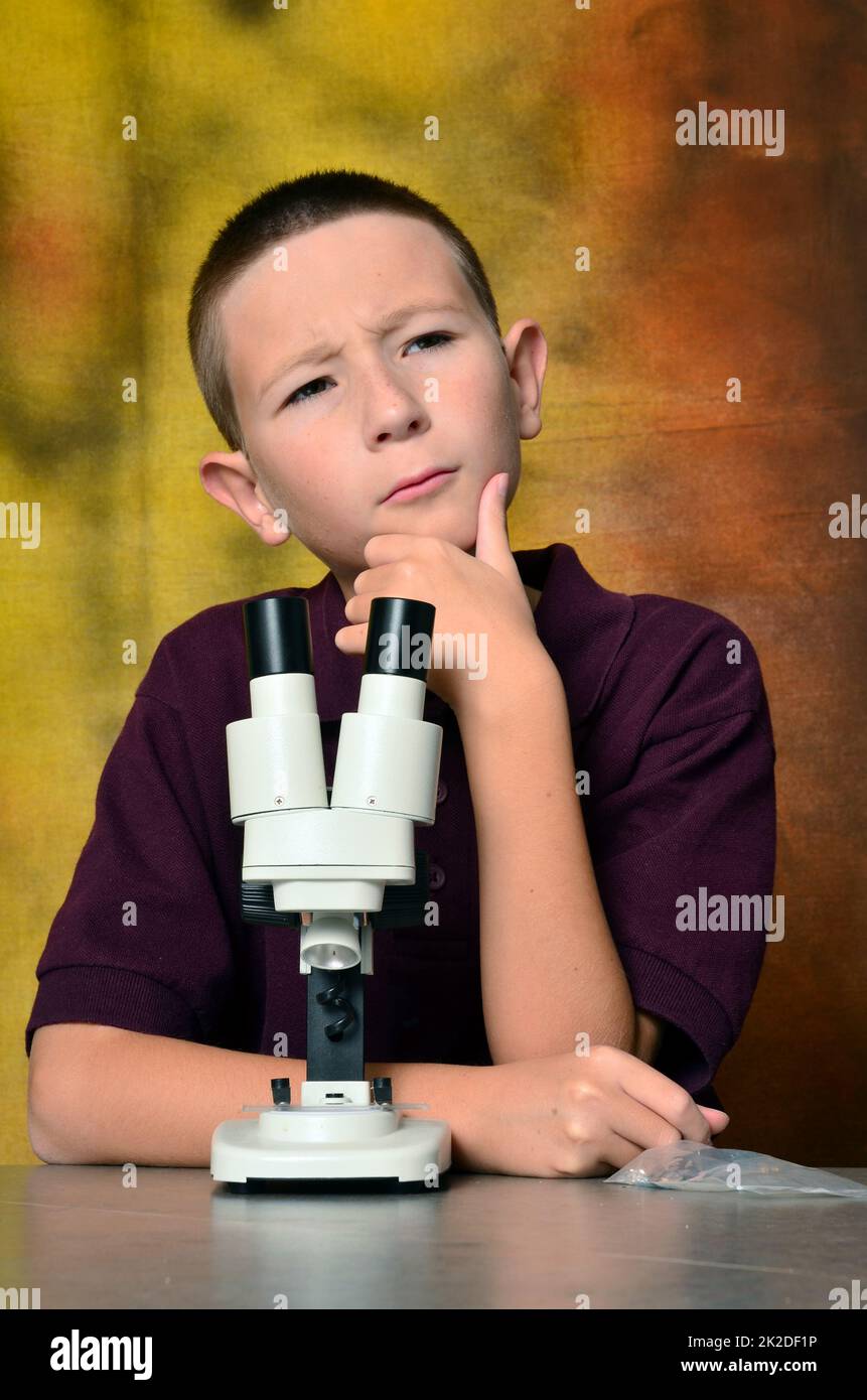 Young Boy Using a Microscope Stock Photo - Alamy