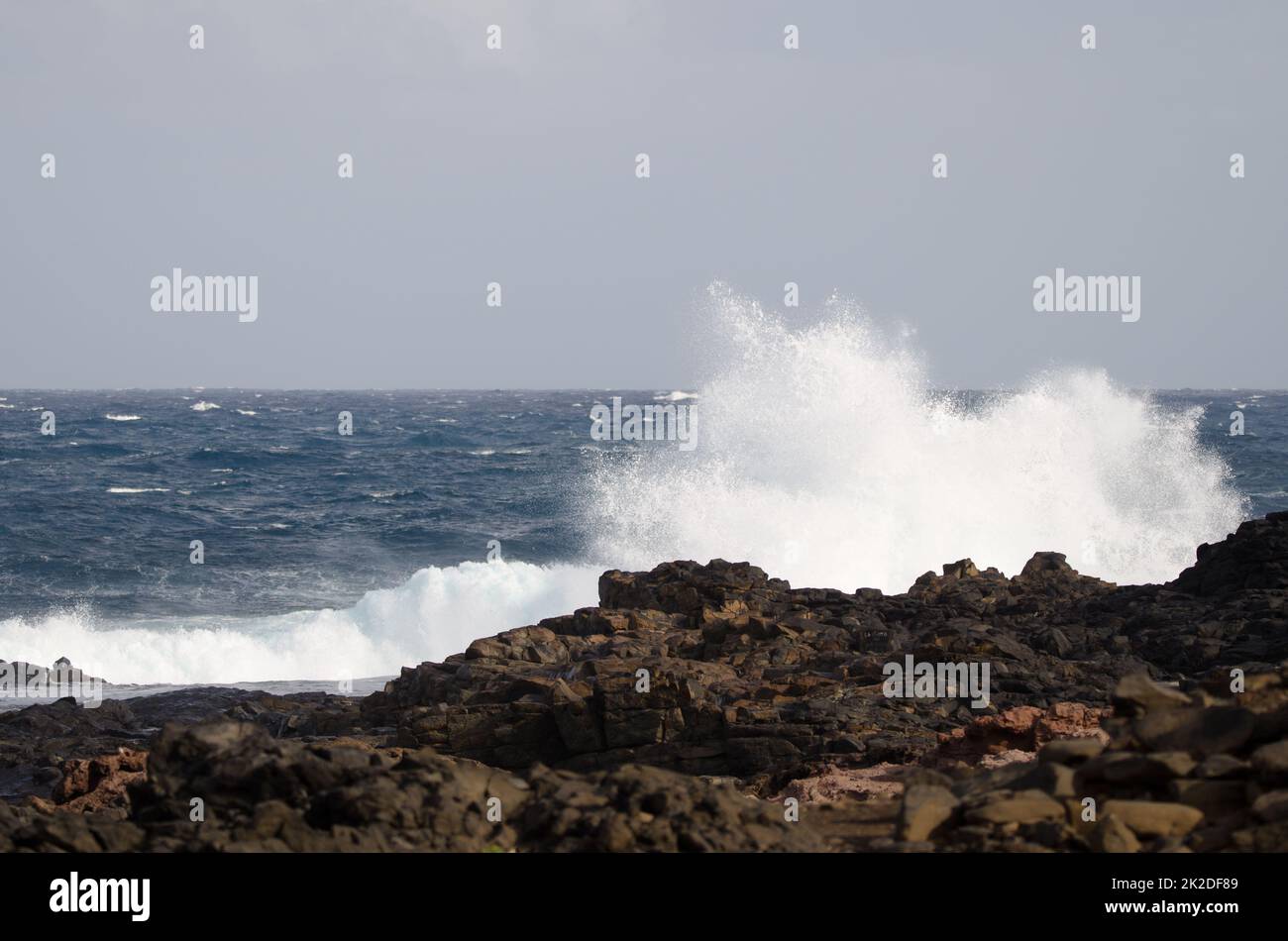 Wave breaking against the shore Stock Photo - Alamy
