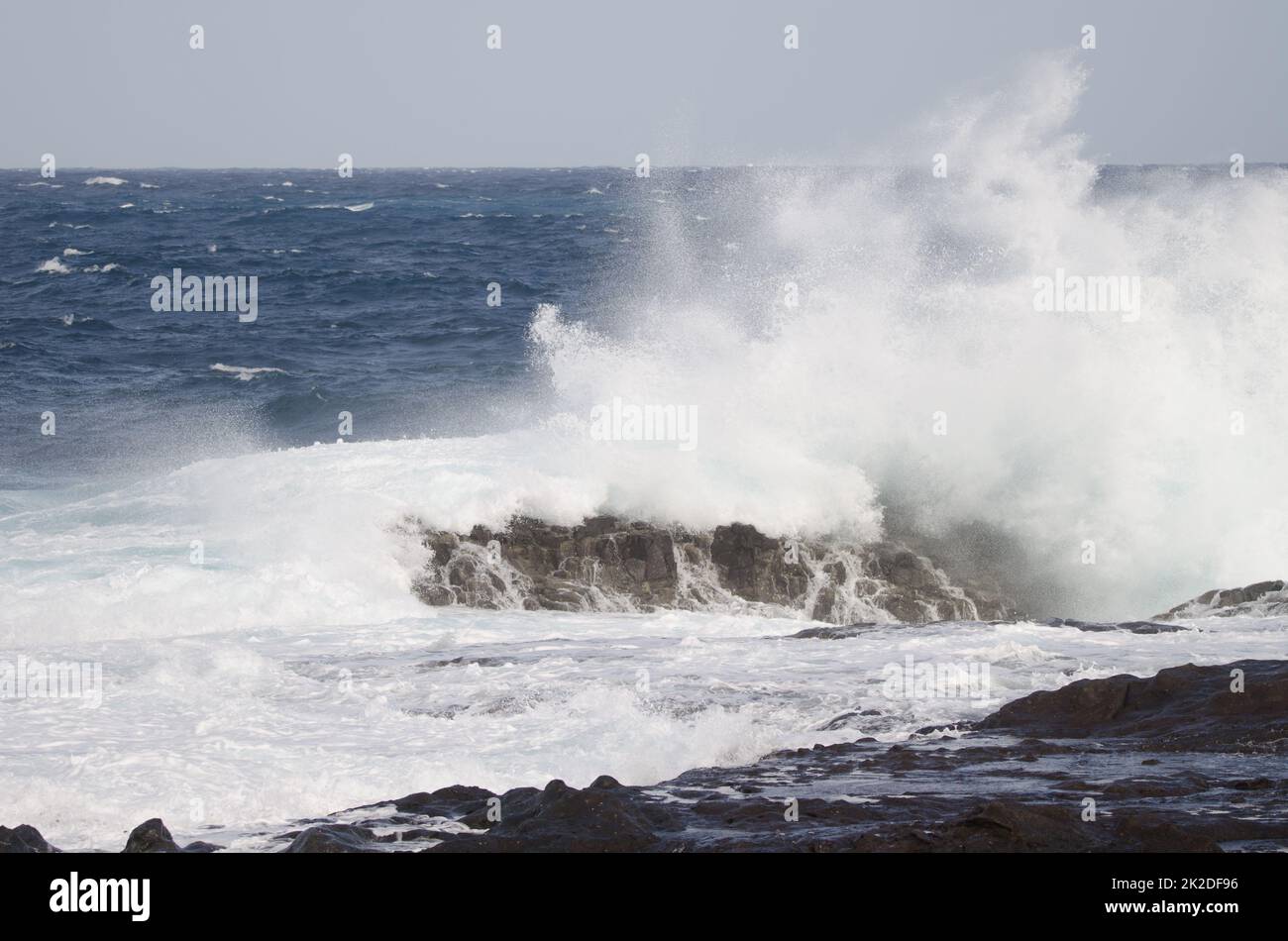 Wave breaking against the shore Stock Photo - Alamy