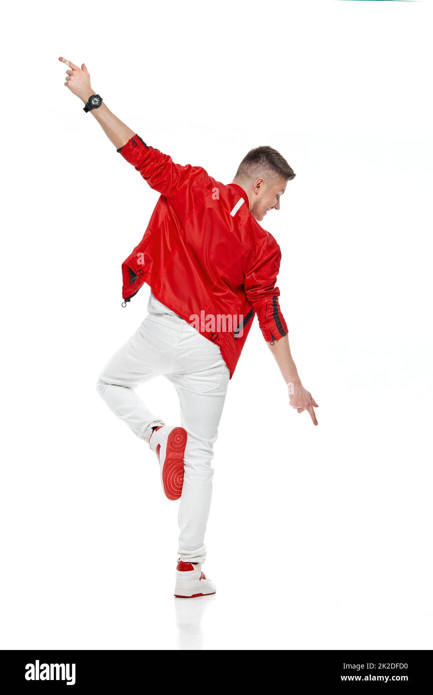 young man standing dancing rising leg spreading hands Stock Photo - Alamy