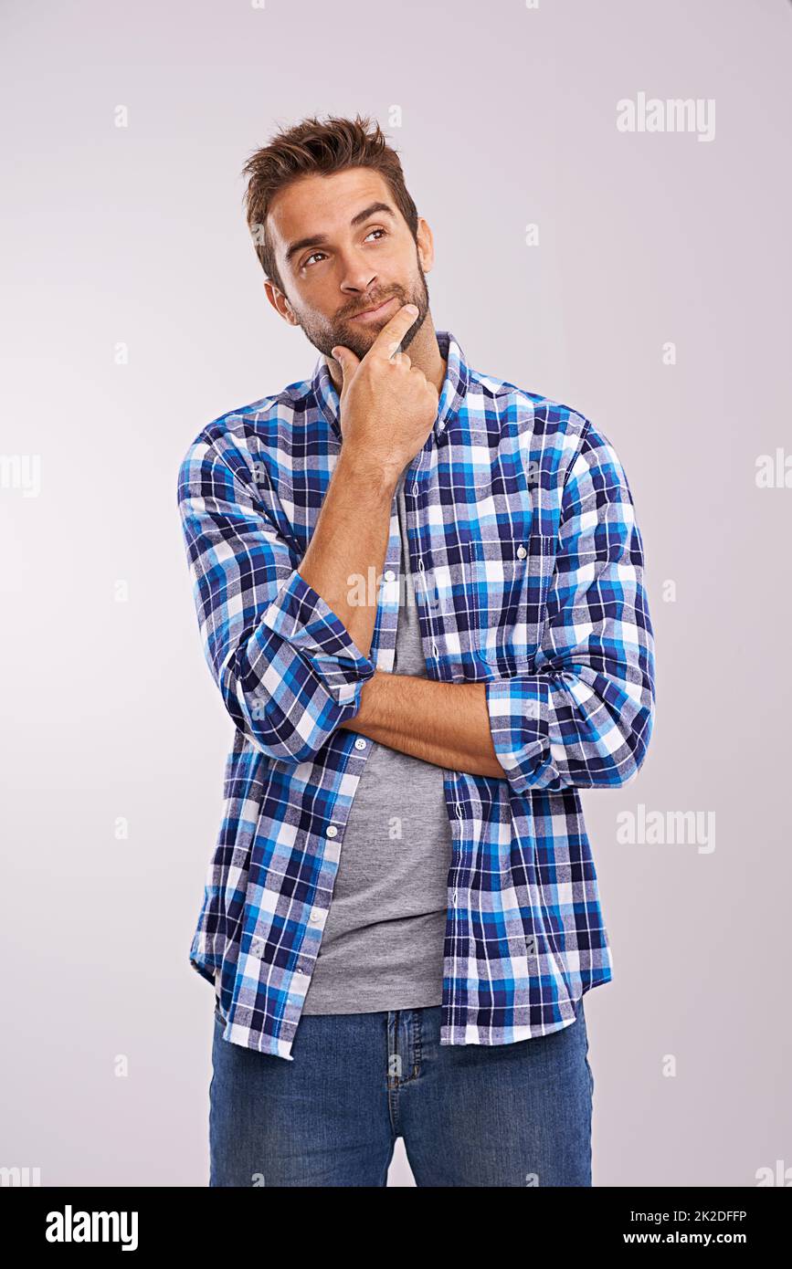 Now thats a thinker. a handsome young man in deep thought against a ...