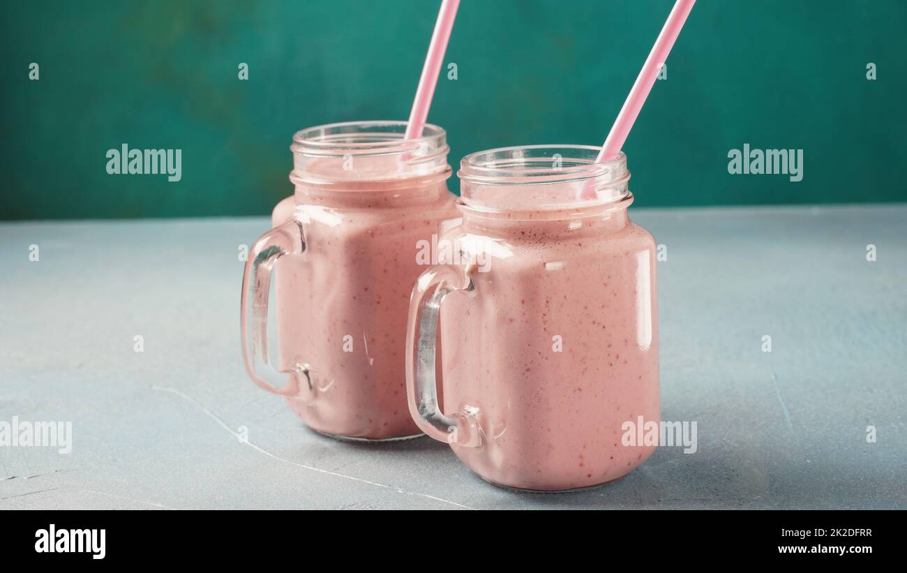 Strawberry milkshake in mason jars with fresh strawberries Stock Photo ...