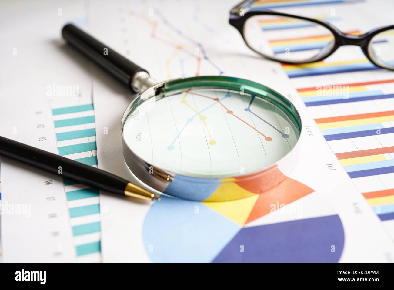 Magnifying glass on charts graphs paper. Financial development, Banking ...