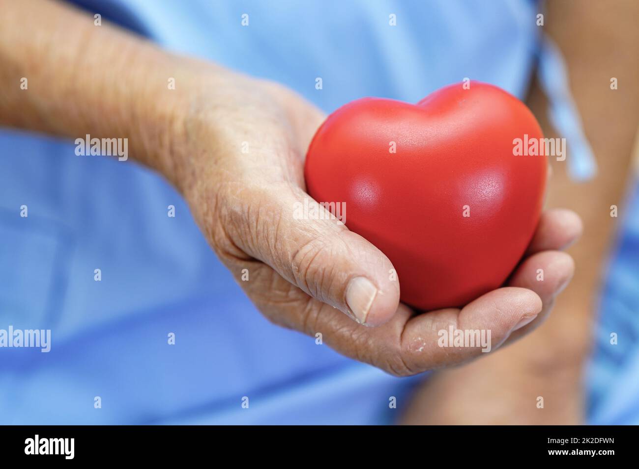 .Asian elder senior woman patient holding red heart in hospital Stock ...