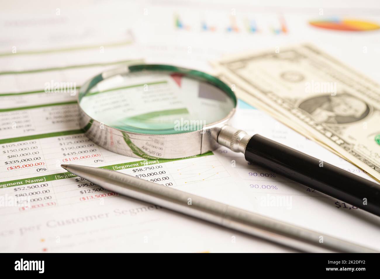 Magnifying glass on US dollar and EURO banknotes and graph, finance ...