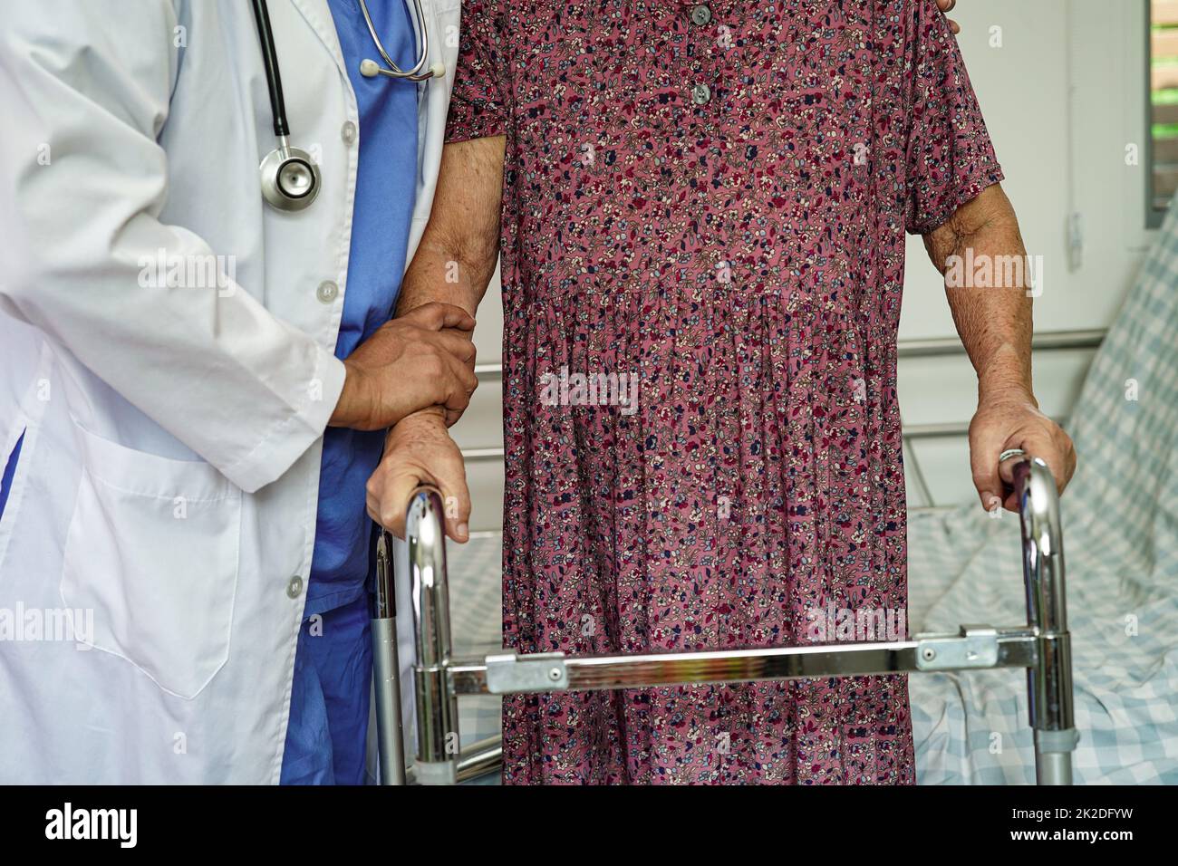Doctor help Asian elderly woman disability patient walk with walker in ...