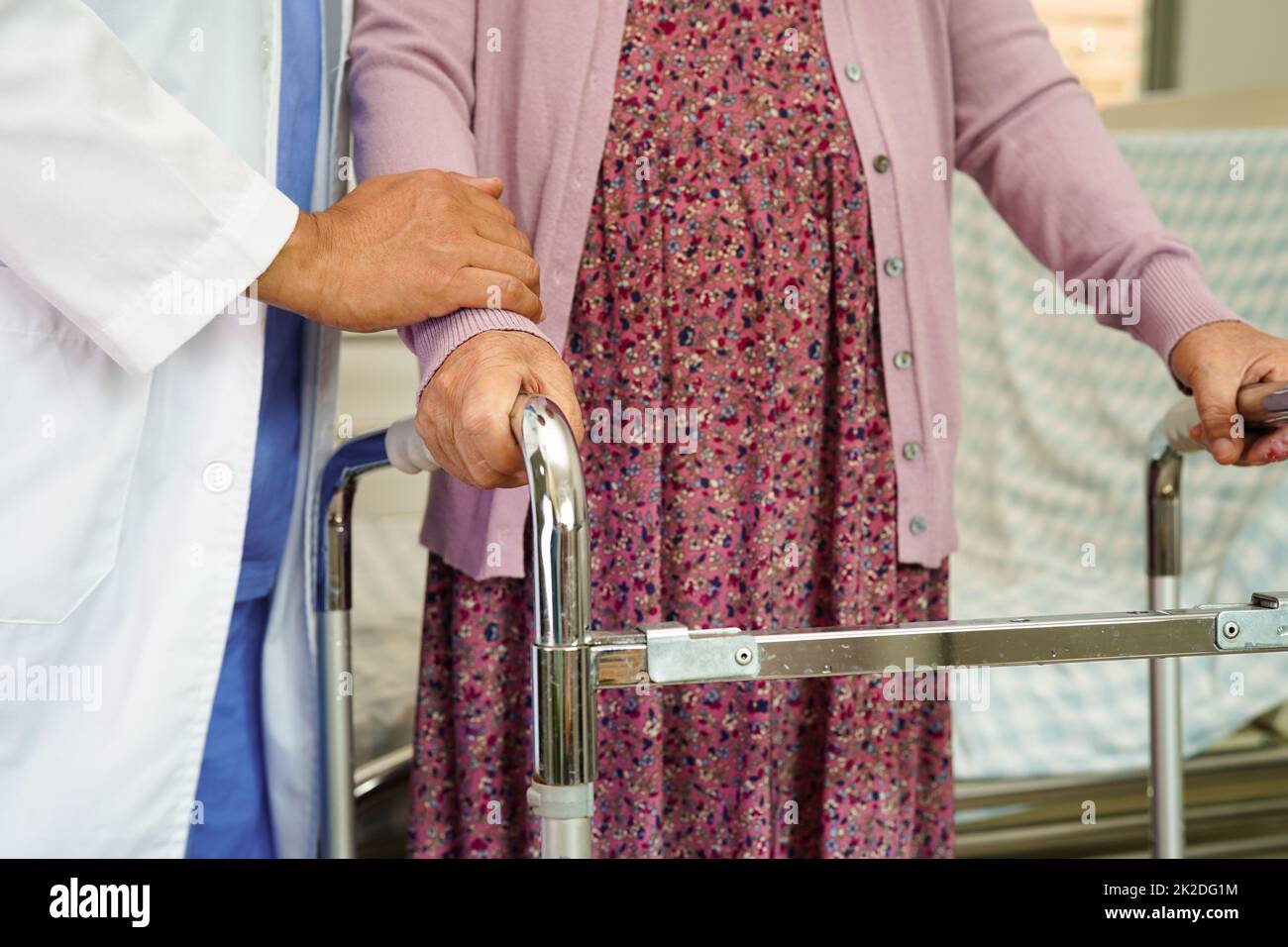 Doctor help Asian elderly woman disability patient walk with walker in ...