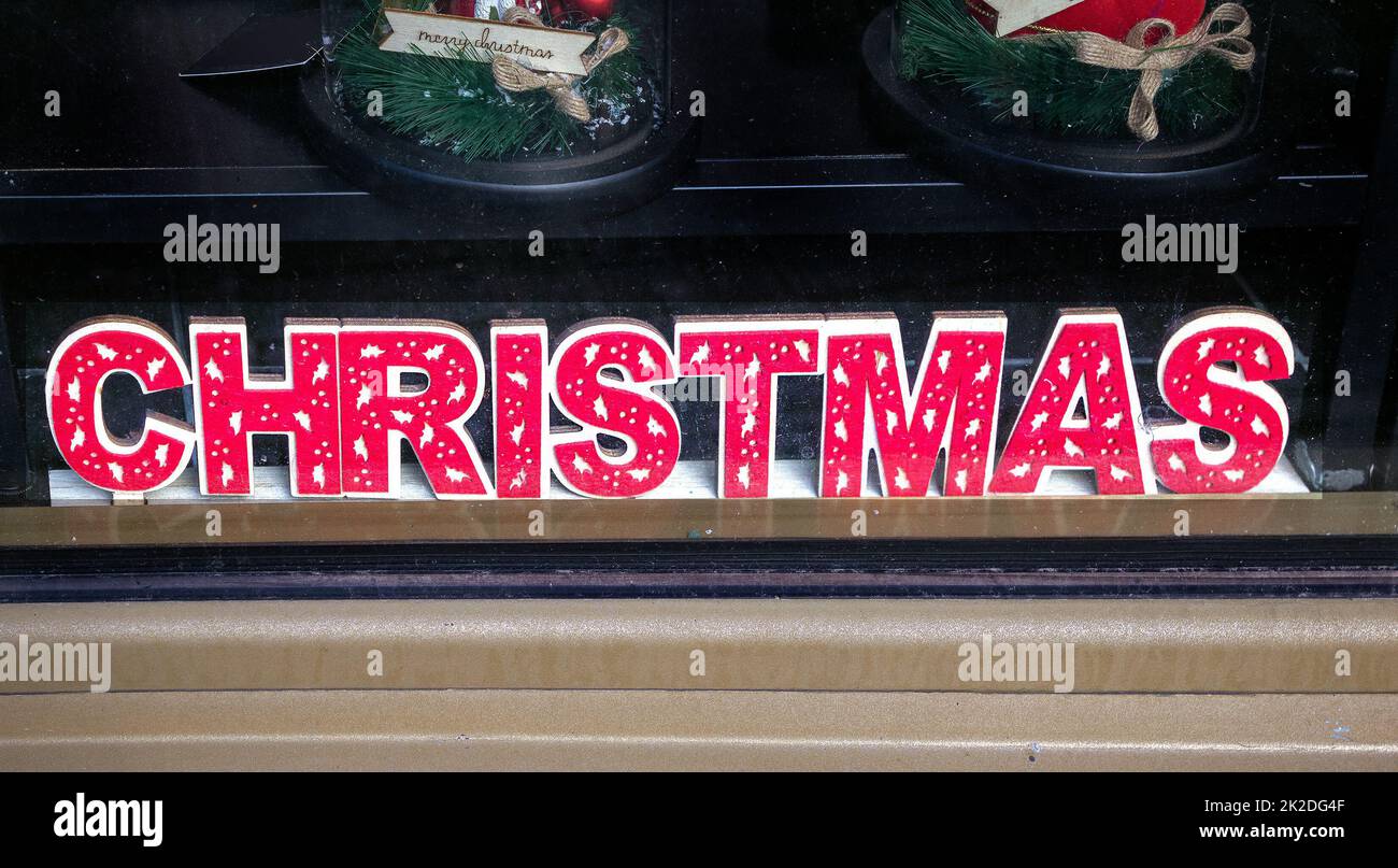 Christmas decoration sign inside shop window Stock Photo - Alamy