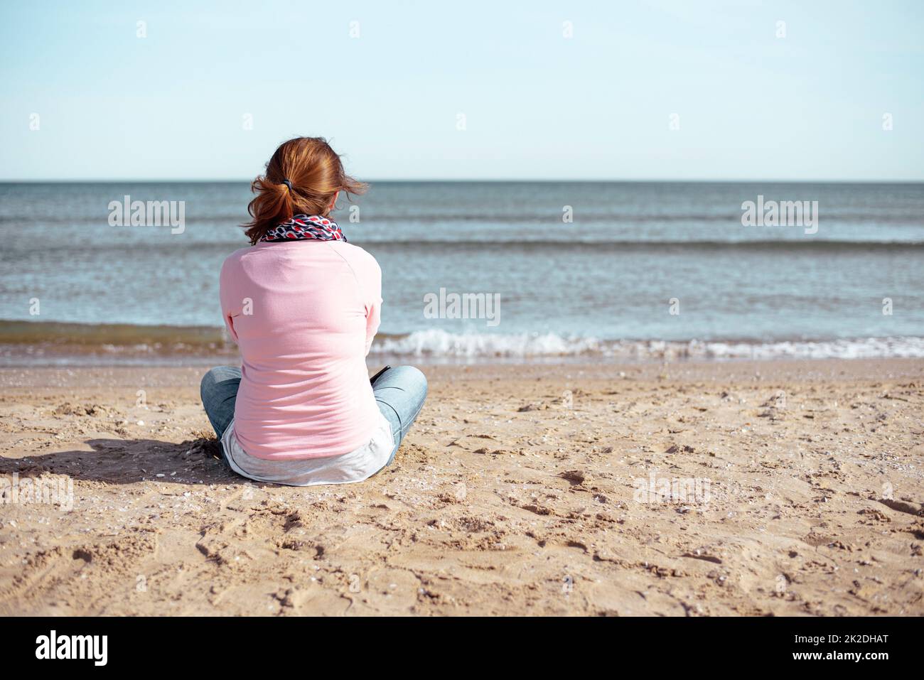 Girl Sitting Alone On Beach