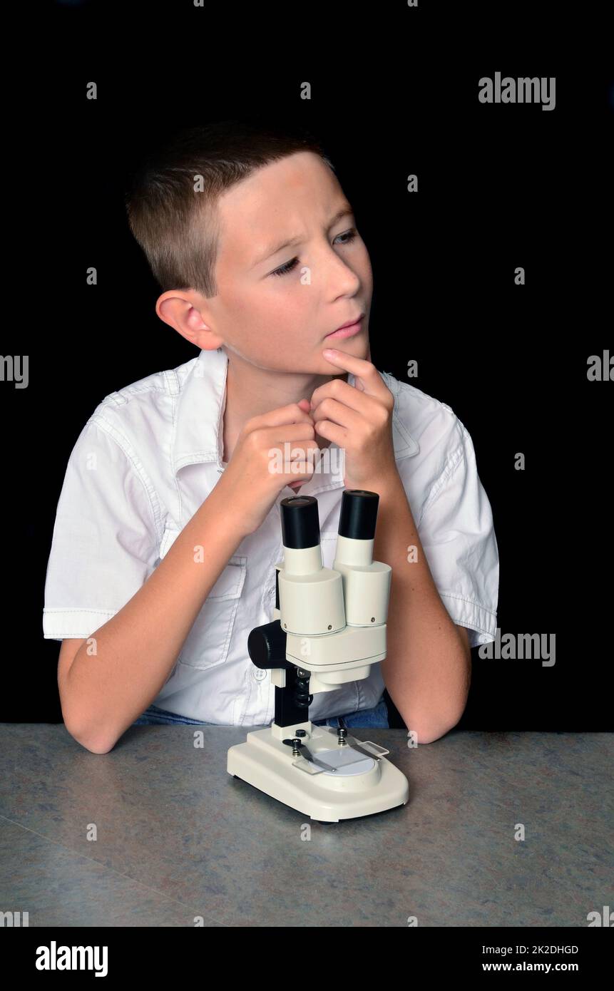 Young Boy Using a Microscope Stock Photo - Alamy