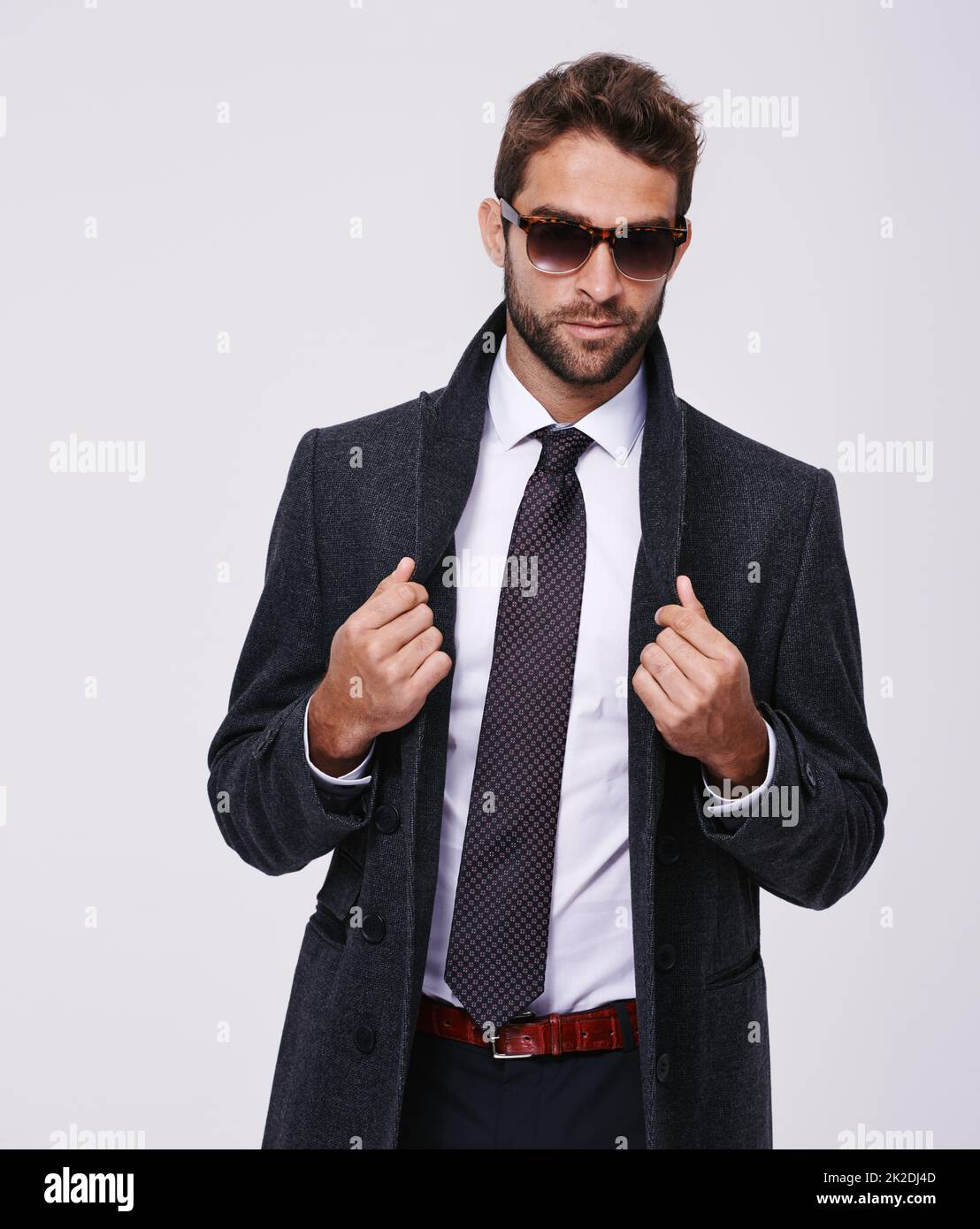Stylish and ready for work. Studio shot of a handsome and well-dressed ...
