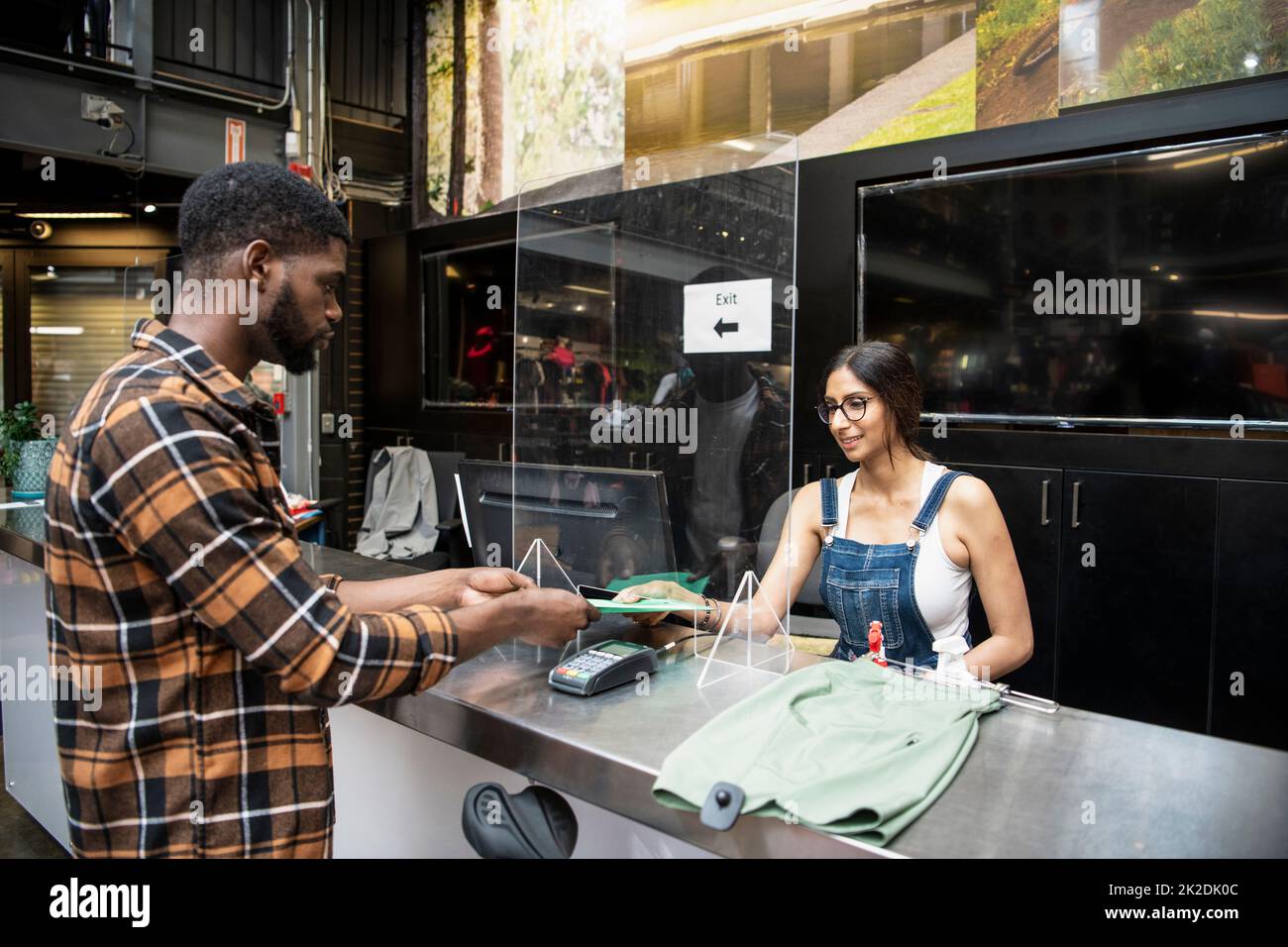 Mid adult cashier hi-res stock photography and images - Alamy