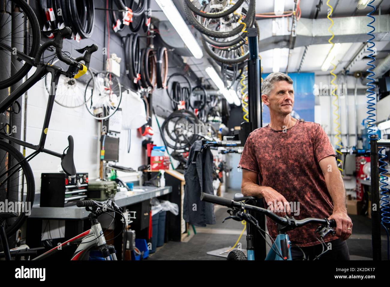 Portrait man standing bike shop hi-res stock photography and images - Alamy