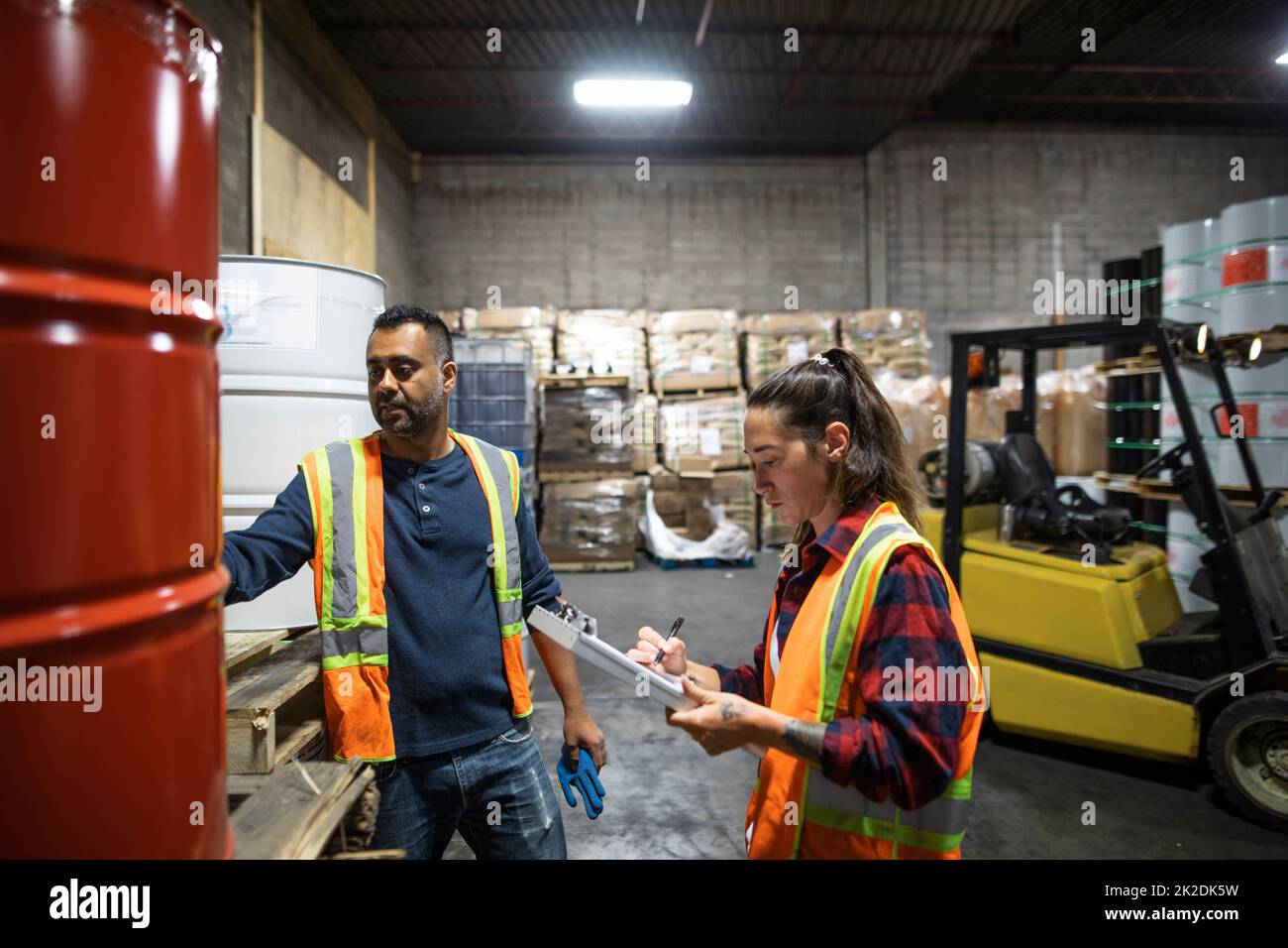 Staff working on inventory tracking in distribution warehouse Stock ...
