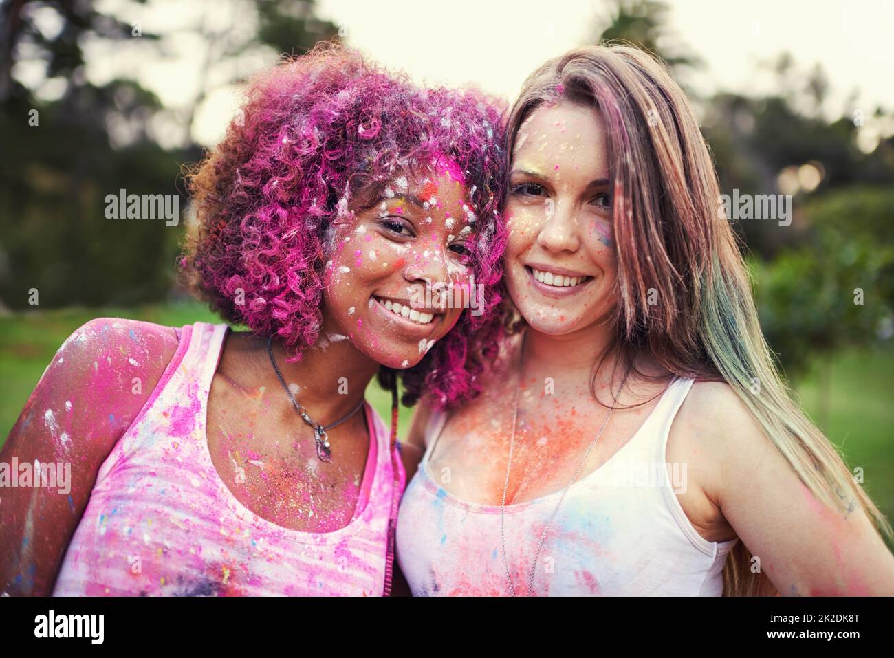 Add some color. happy friends having fun with powder paint Stock Photo ...