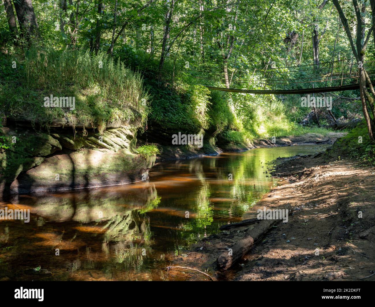 Perry Creek flows under a suspension bridge in the Perry Creek ...