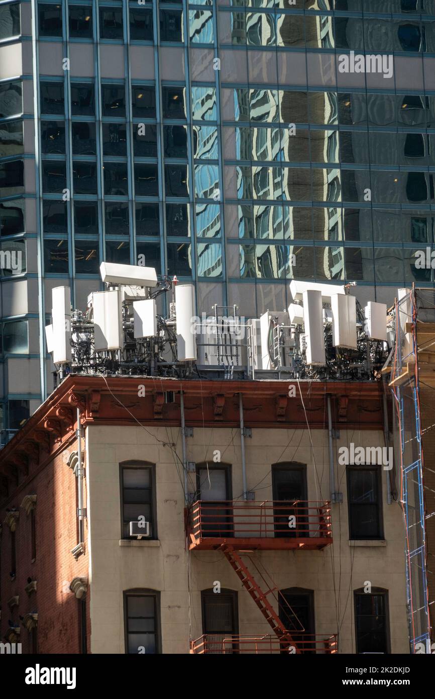Multiple cell tower receivers on a low rise brownstone on third Ave ...