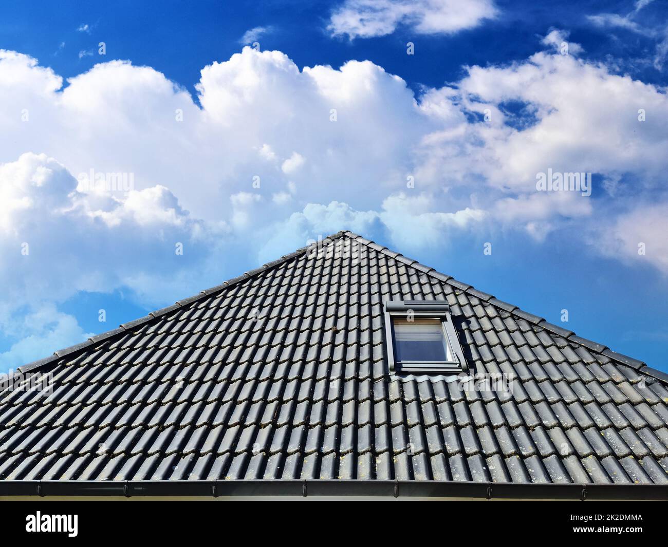 Open roof window in velux style with black roof tiles Stock Photo - Alamy