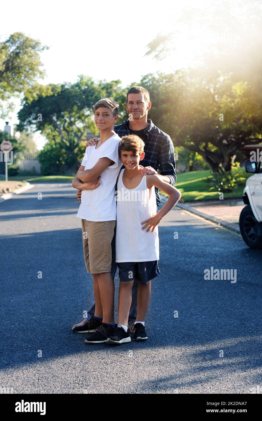 Dad and his two cool kids. Portrait of a father standing with his two ...