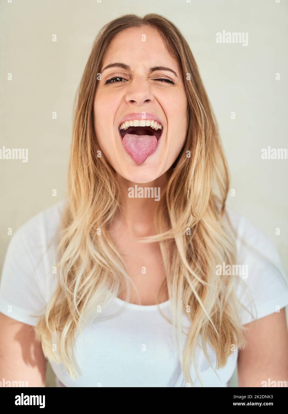 Young woman sticking out her tongue hi-res stock photography and images - Alamy